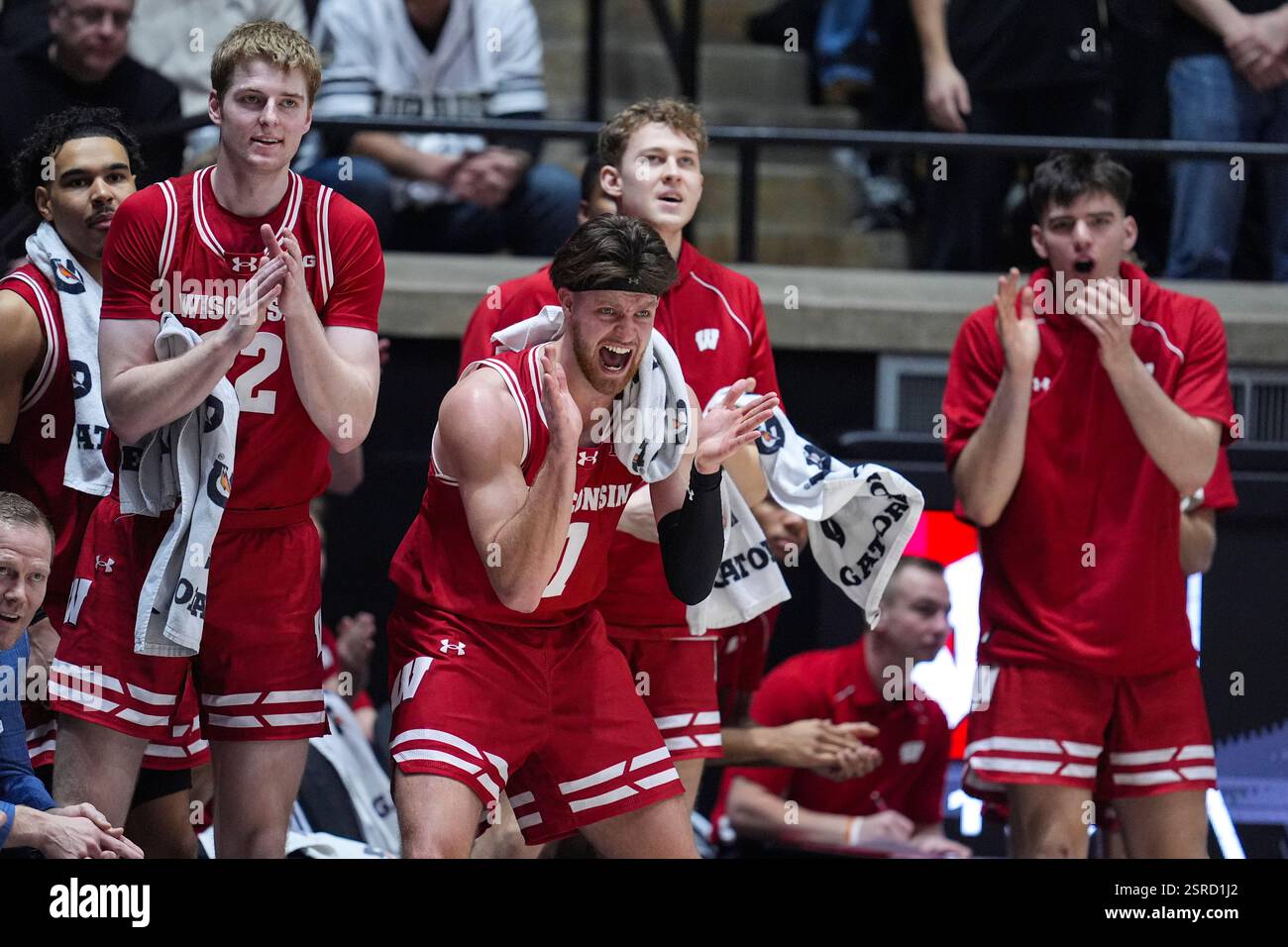 The Wisconsin bench, including forward Carter Gilmore (7), celebrates ...