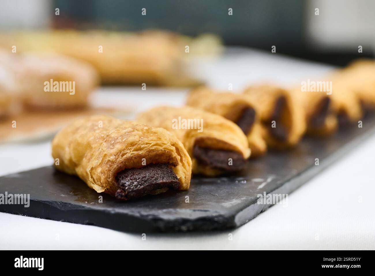 Chocolate filled puff pastry sweets Stock Photo - Alamy
