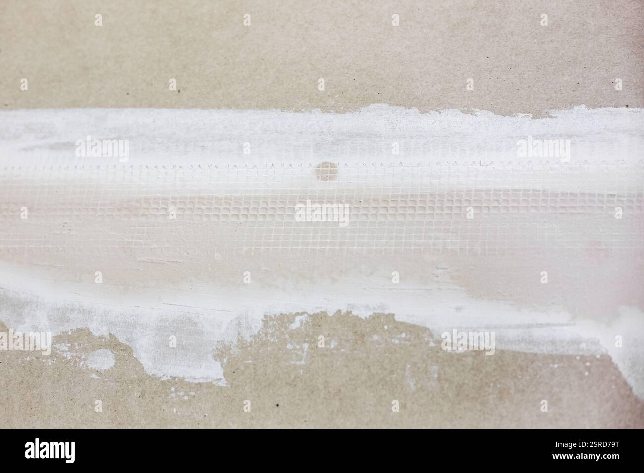 Preparing drywall for plastering. The drywall joint is filled and ...