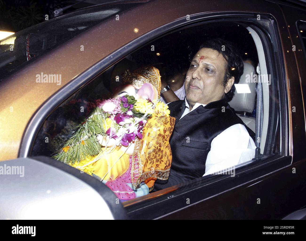 Bollywood actor Govinda participates in a procession for the immersion ...