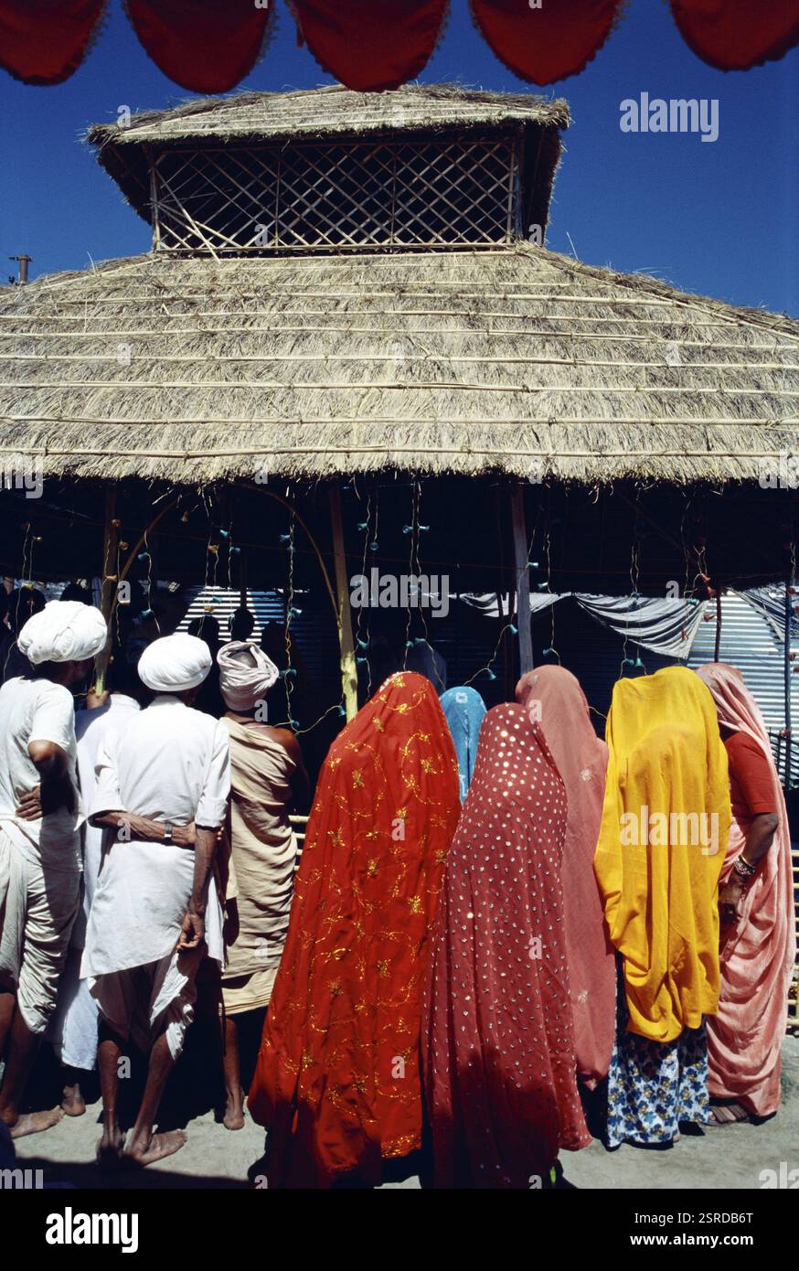 Villagers watching havan in Kumbh fair 98, Haridwar, Uttaranchal, India ...