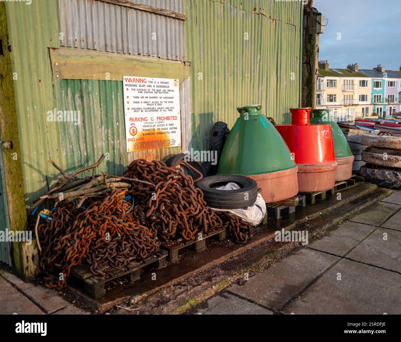 Anchor chains and buoys on pallets on the quay next to the River Teign ...