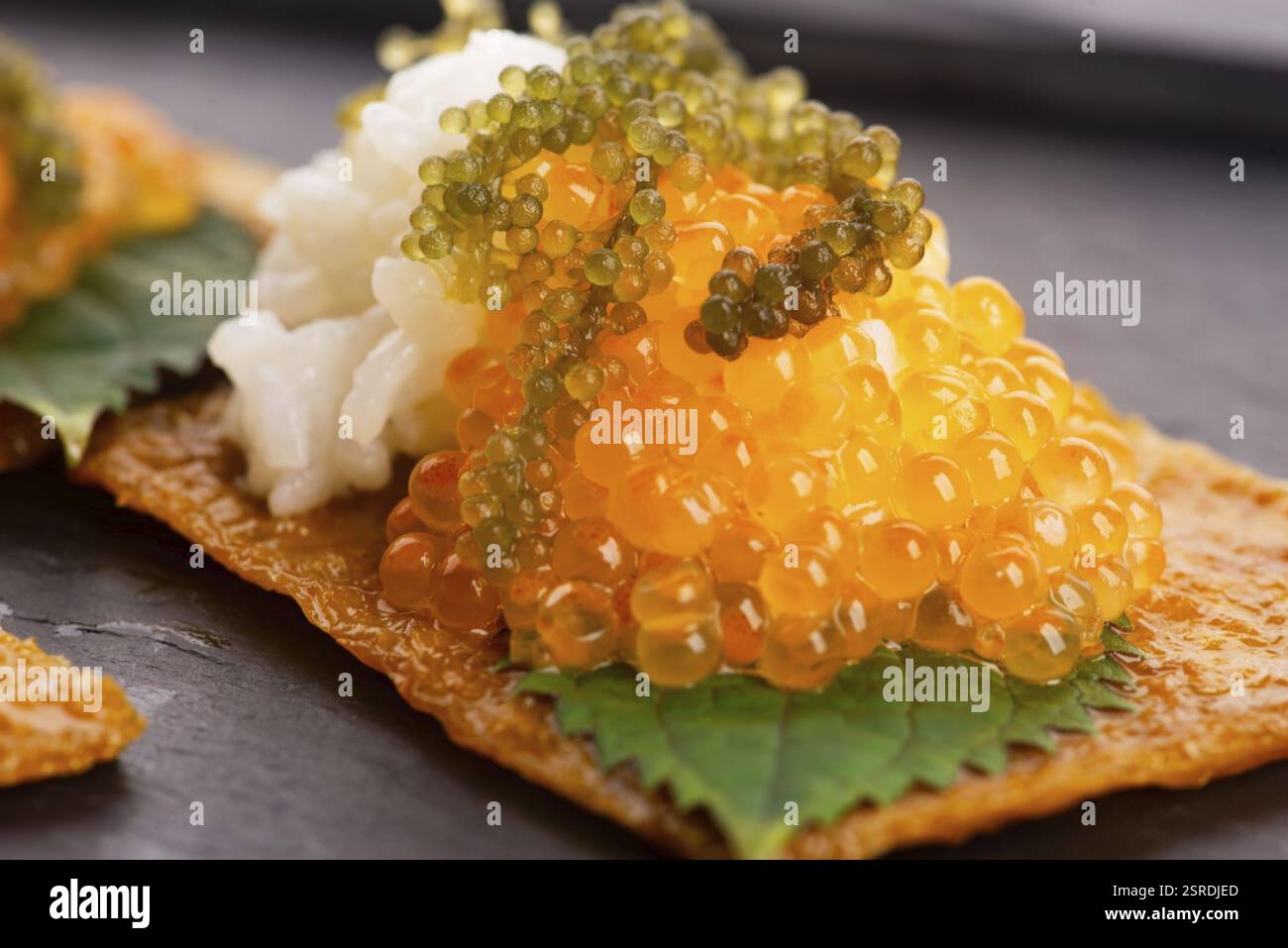 Inari sushi with caviar, rice, shiso and umibudo Stock Photo - Alamy