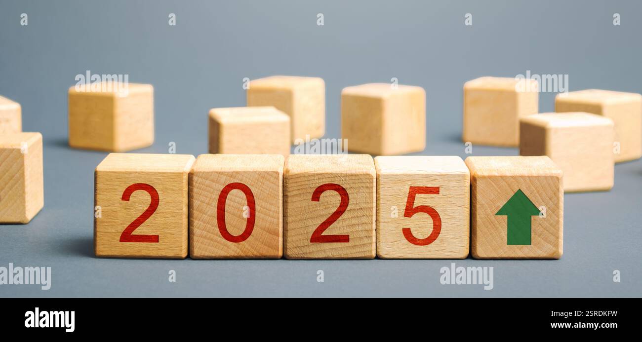 Wooden blocks with the inscription 2025 and arrow up. Setting goals and ...