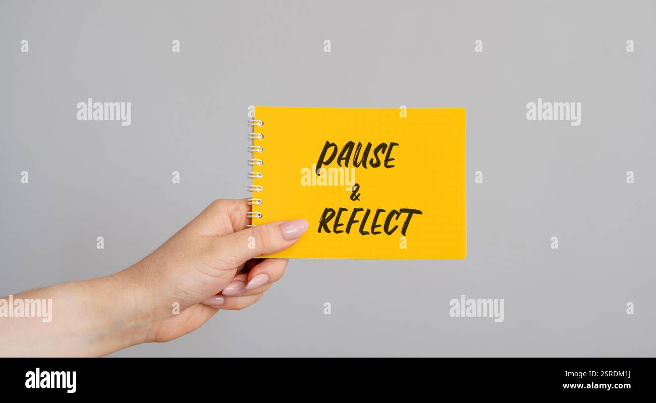 Notes Pause and reflect in a female hand. Stop, think, and assess a ...