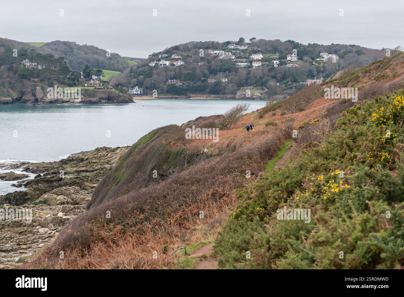 Two distant people walking a dog along an East Portlemouth section of ...