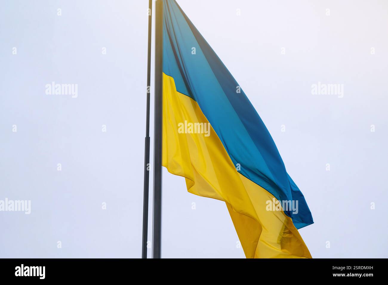 Ukraine flag, national symbol fluttering in blue sky. Large yellow blue ...