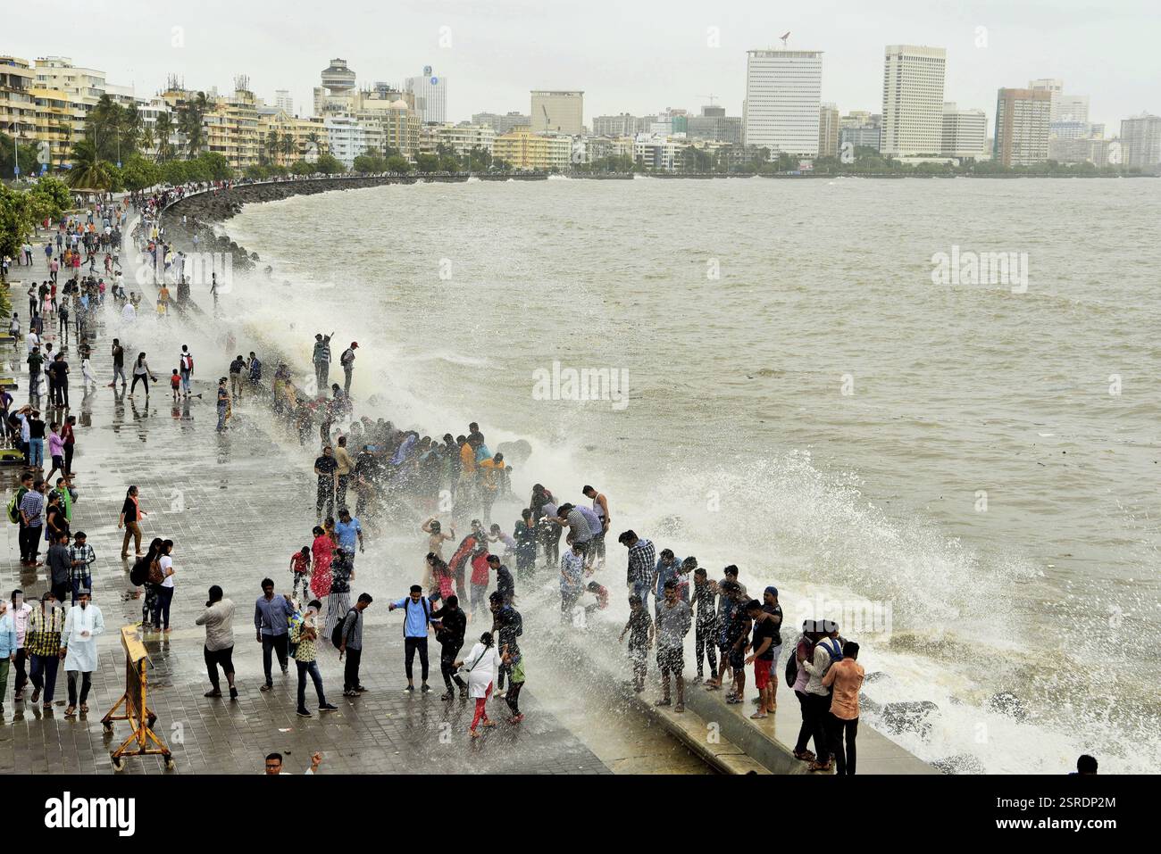 People enjoying monsoon sea waves at Marine Drive, Mumbai, Maharashtra ...