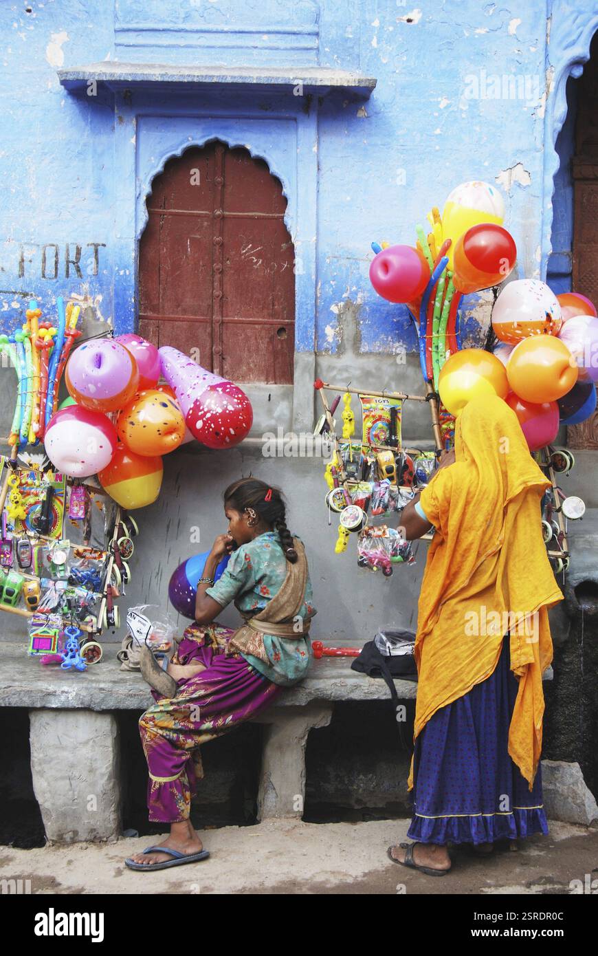 Balloon vendor in front of blue house, Jodhpur, Rajasthan, India, Asia ...