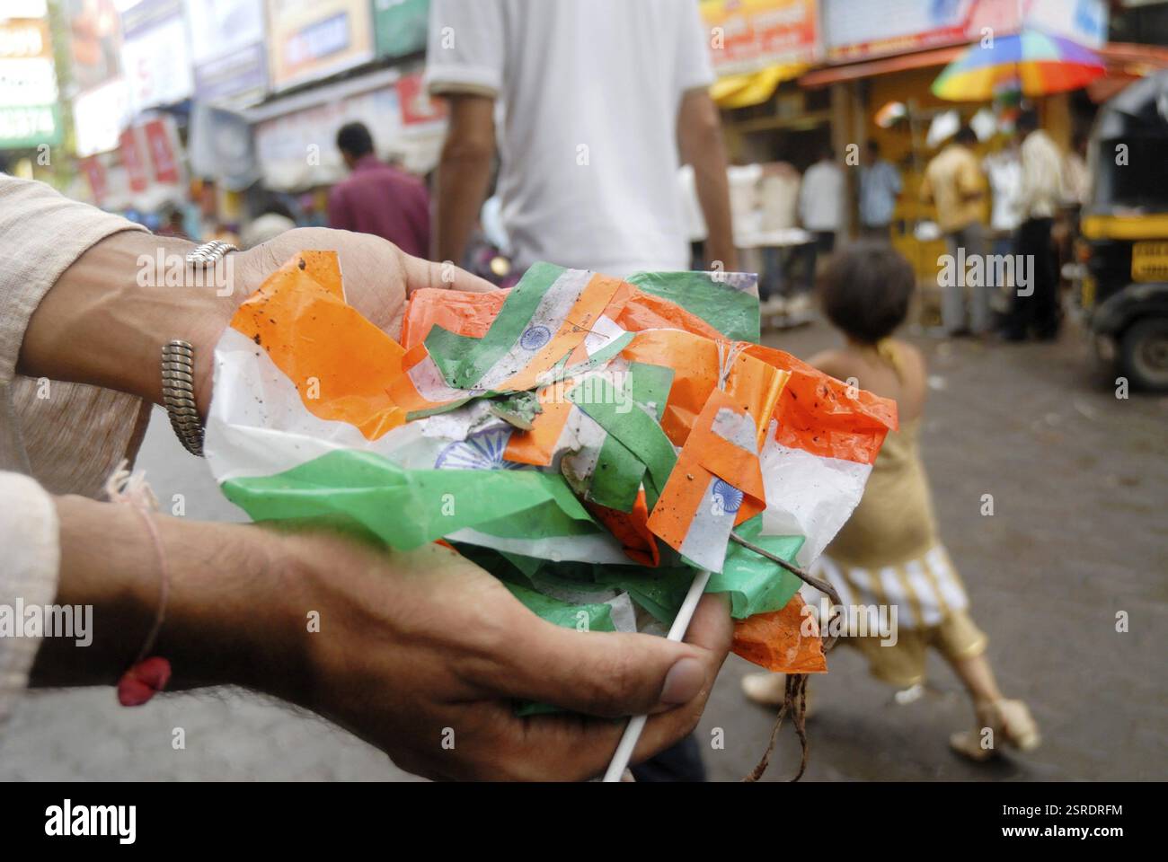 Hand showing thrown plastic Indian tri color flags, Bombay Mumbai ...