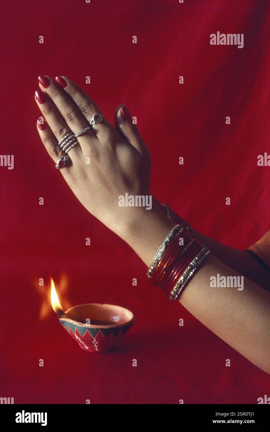 Diwali deepawali festival, lady showing namaskar and diya on red ...