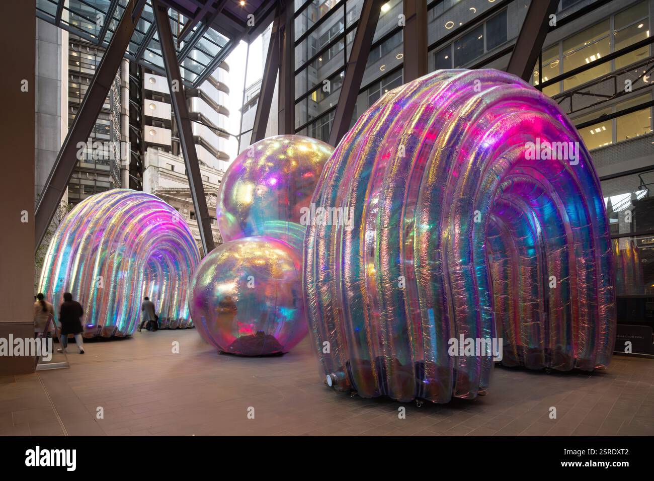 Inflatable iridescent structures, spheres and arches, adorn the ...
