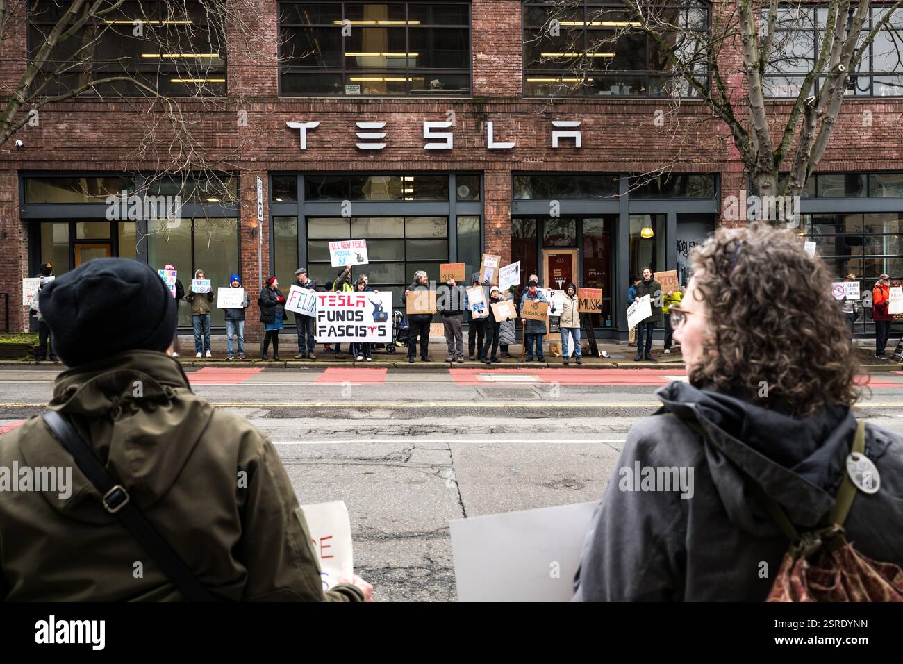 Seattle, USA. 15th Feb 2025. Activists gather during the Tesla Takeover ...