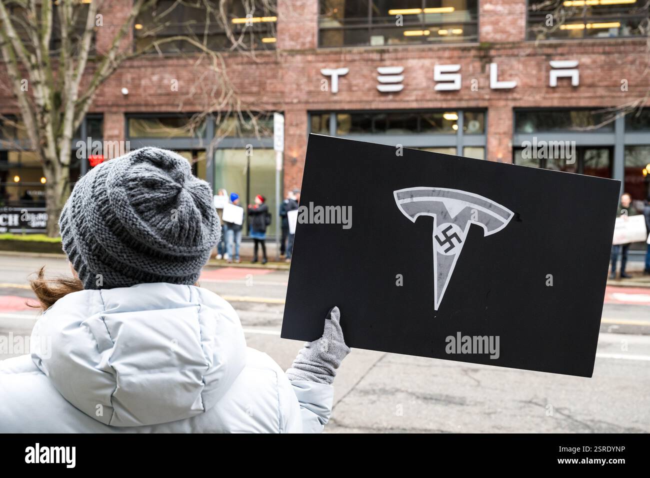 Seattle, USA. 15th Feb 2025. Activists gather during the Tesla Takeover ...