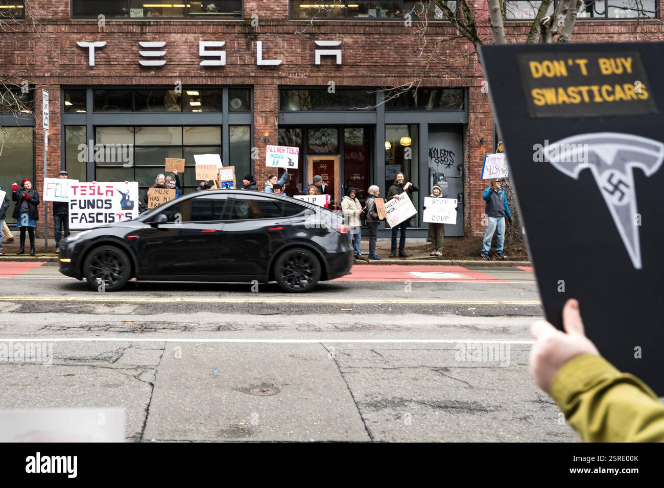 Seattle, USA. 15th Feb 2025. Activists gather during the Tesla Takeover ...