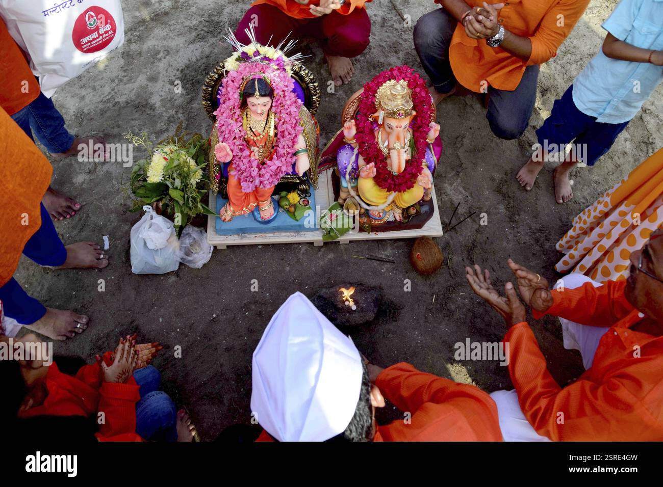 Devotees perform pooja before carrying an idol of elephant headed Hindu ...