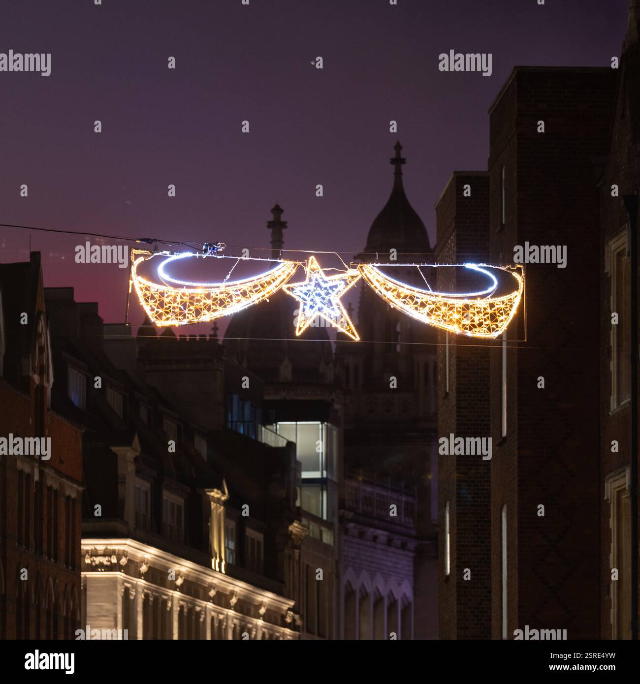 Illuminated Christmas lights, shaped like stars and crescent moons ...