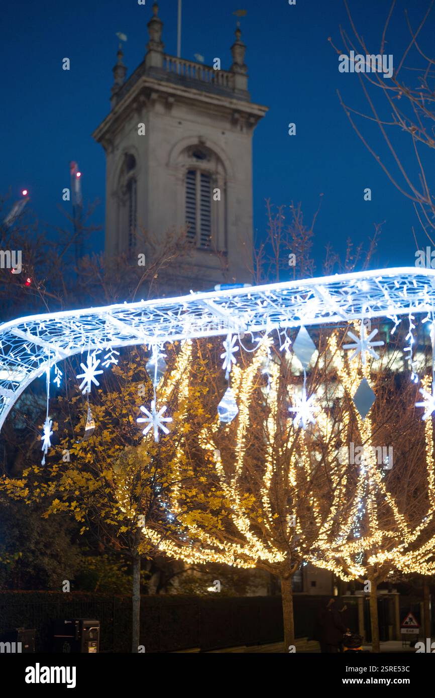 Christmas lights adorn trees in front of a church at night, Holborn ...