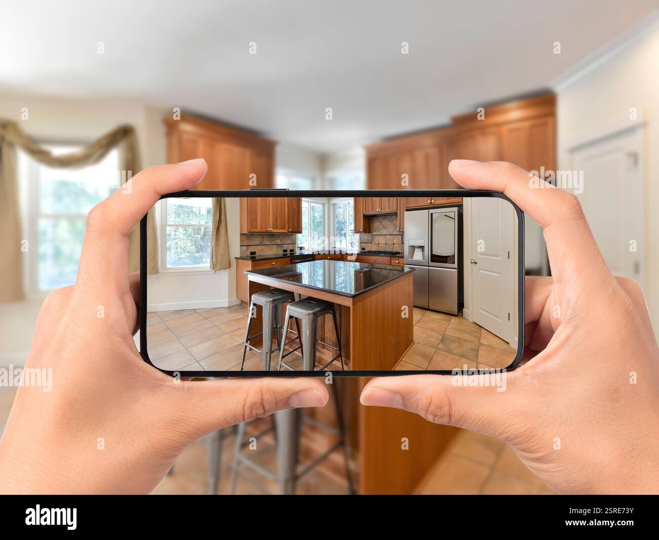 Person taking a photo of a modern residential kitchen interior with a ...