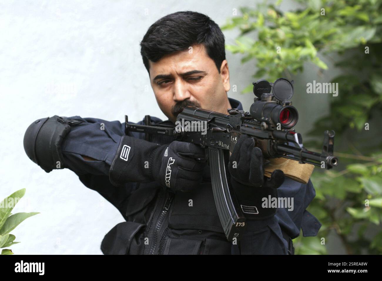 Black Cat commando with an AK 47 light machine gun MR#725 Stock Photo ...