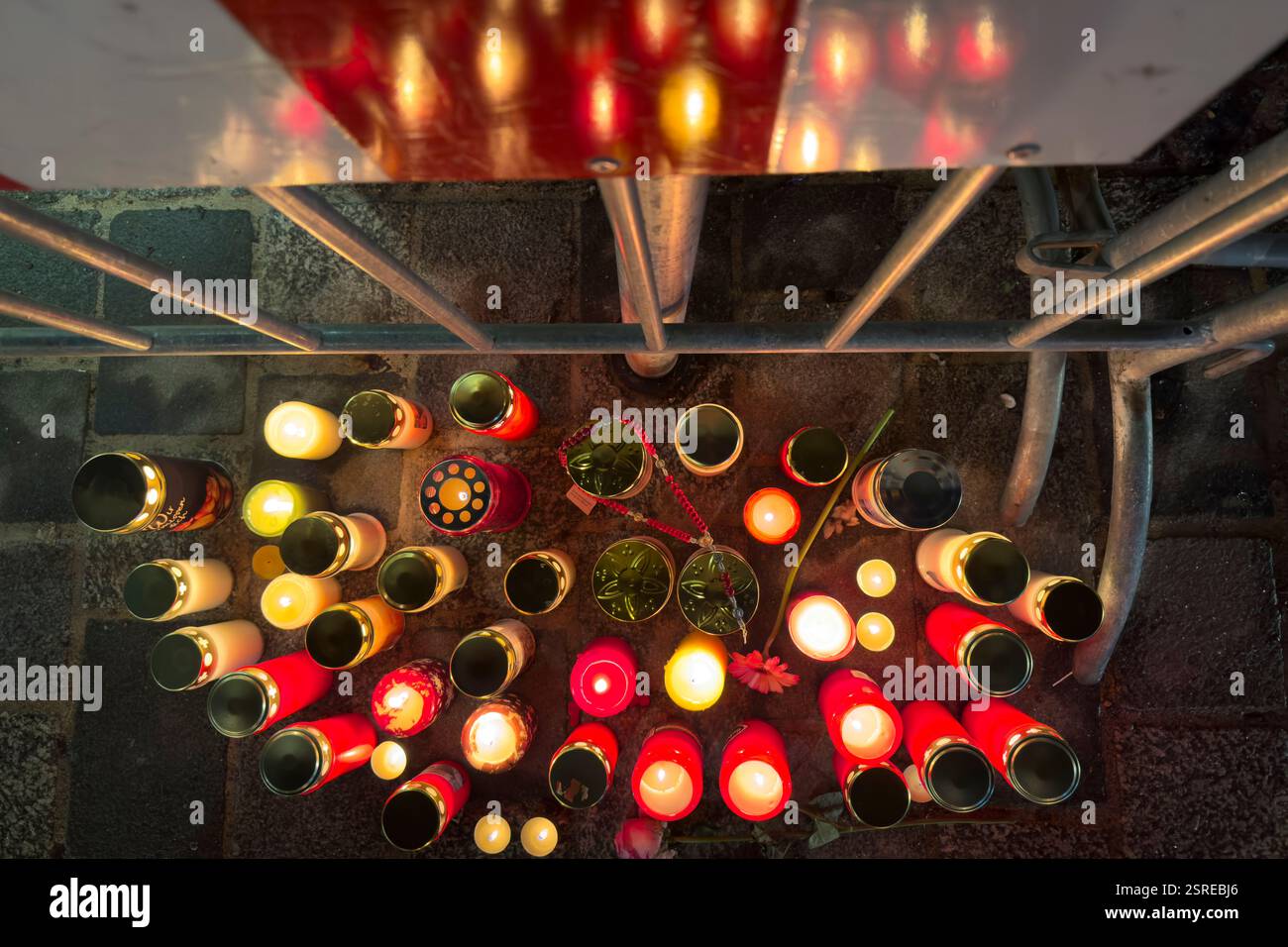 Candles are lit at the site of a stabbing attack in Villach, Austria ...
