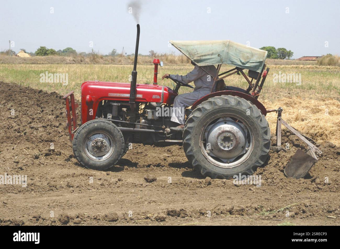 Farmer with tractor in field, Singhpur, Narsinghpur, Madhya Pradesh ...
