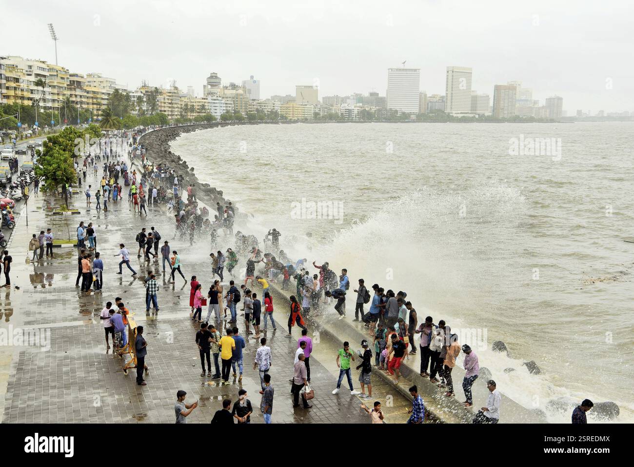 People enjoying monsoon sea waves at Marine Drive, Mumbai, Maharashtra ...