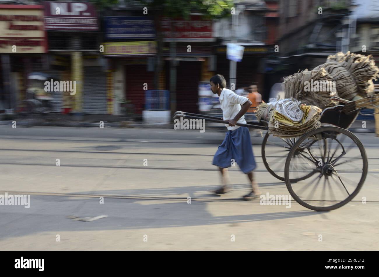 Man pulling rickshaw, Kolkata, West Bengal, India, Asia Stock Photo - Alamy