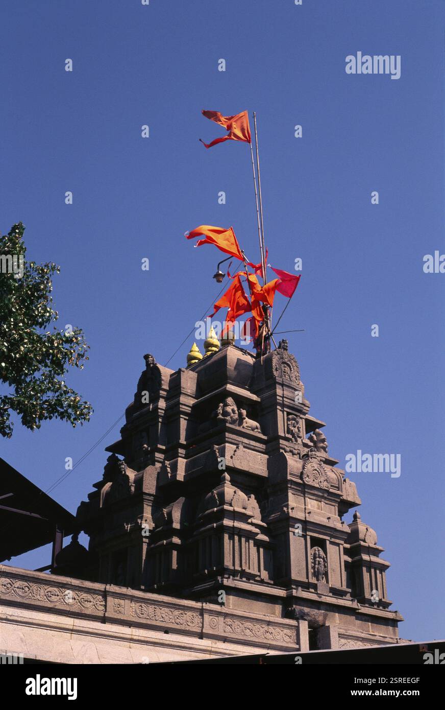 Flags and stone carved pinnacle of Datta temple Gangapur, Karnataka ...