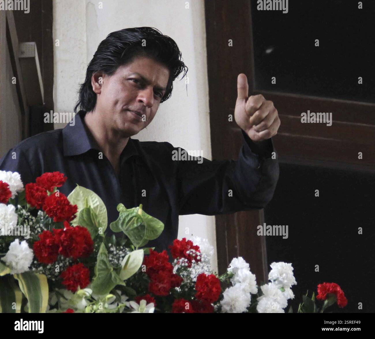 Bollywood actor Shah Rukh Khan waves to crowd who came to greet him on ...
