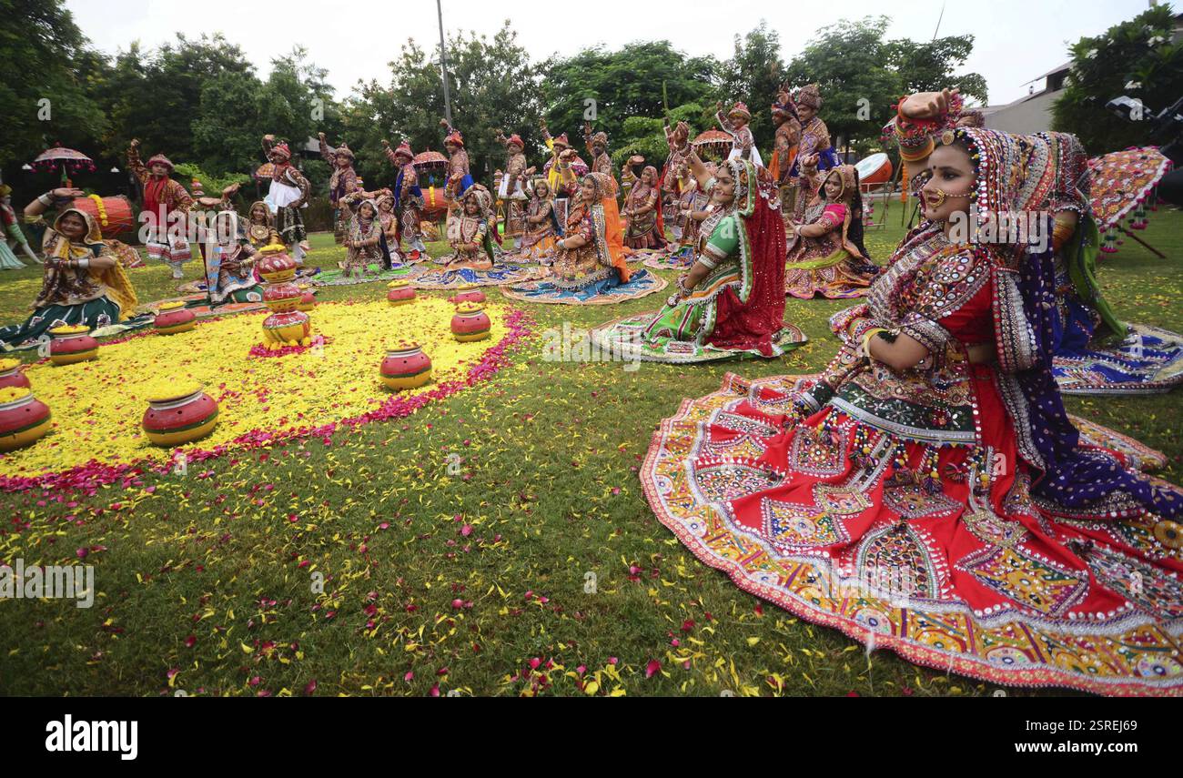 Girls in traditional attire, practice the Garba dance steps in ...