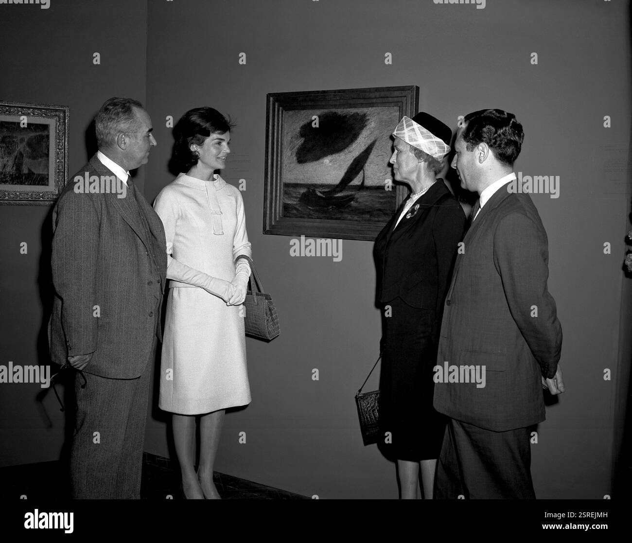 First Lady Jacqueline Kennedy stands before the painting “Under a Cloud ...