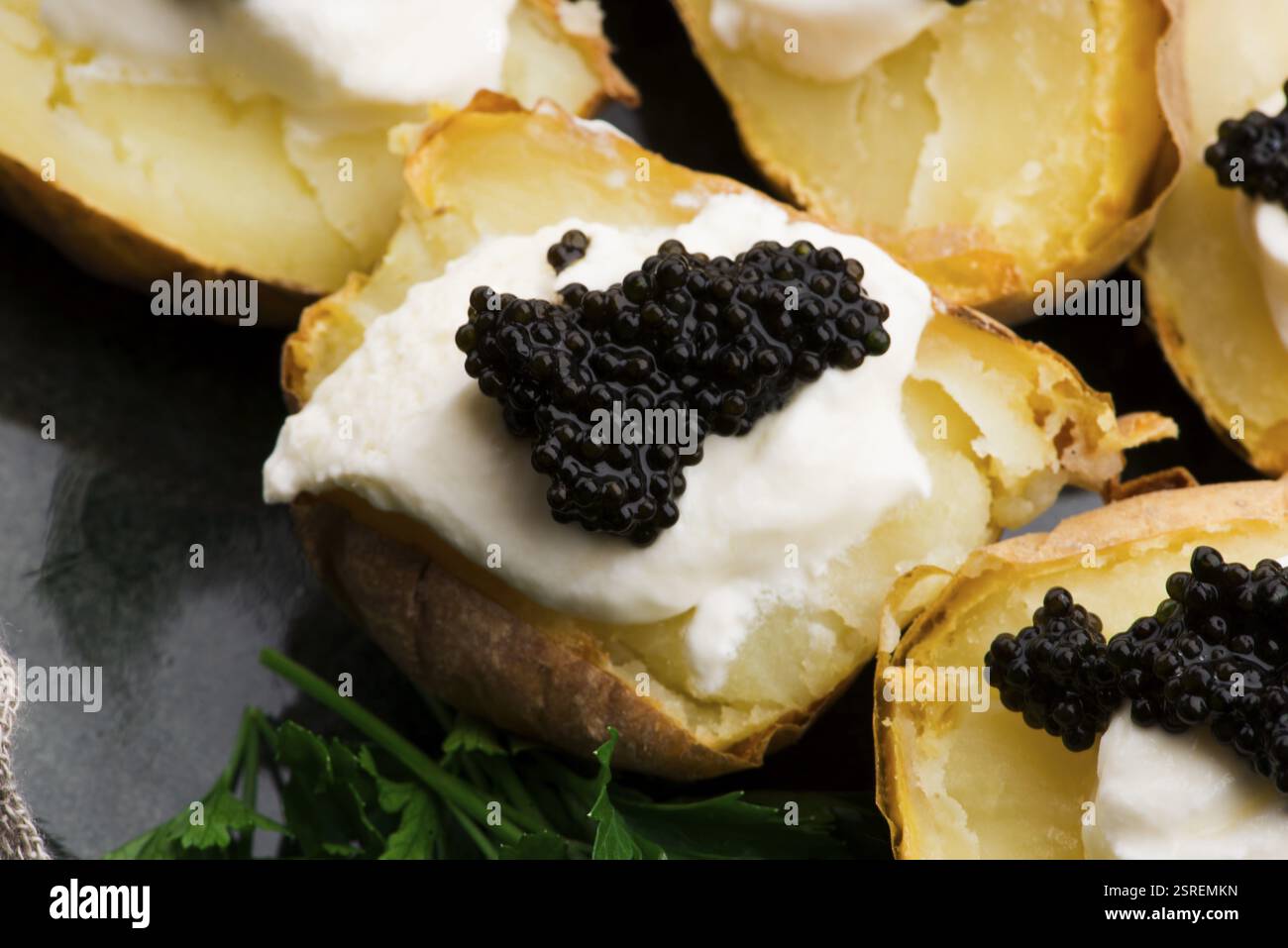 Baked potato with spiced cream cheese and caviar Stock Photo - Alamy