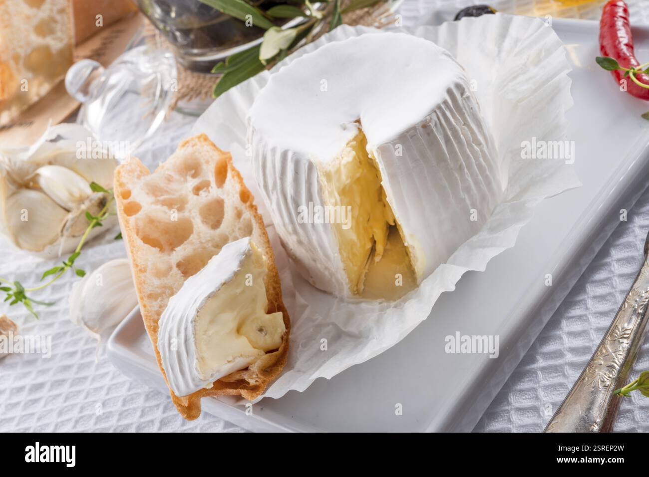 Soft cheese with spicy olives Stock Photo - Alamy