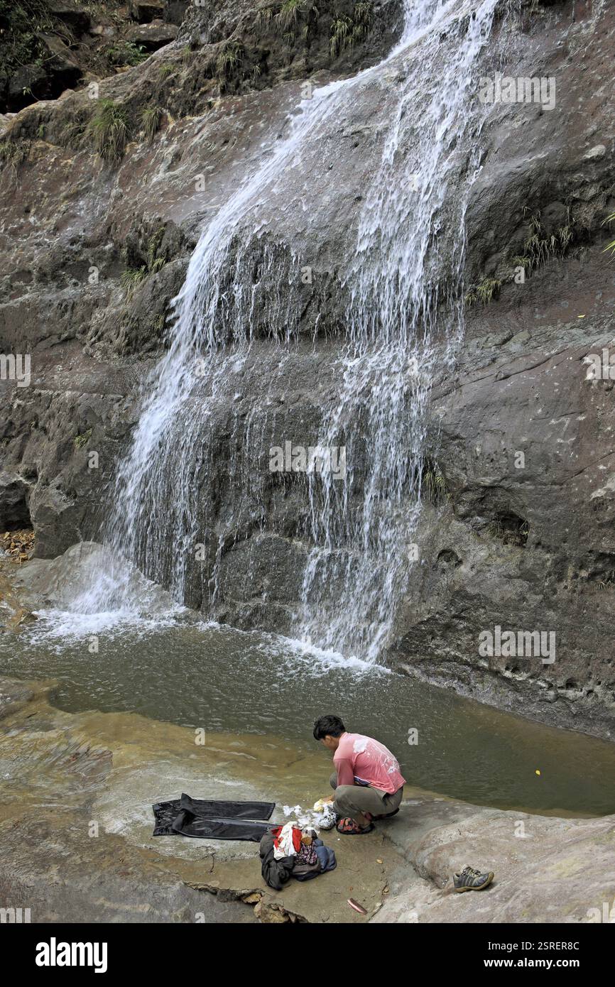 Tribal man washing his clothes near waterfall, Cherrapunji, Meghalaya ...