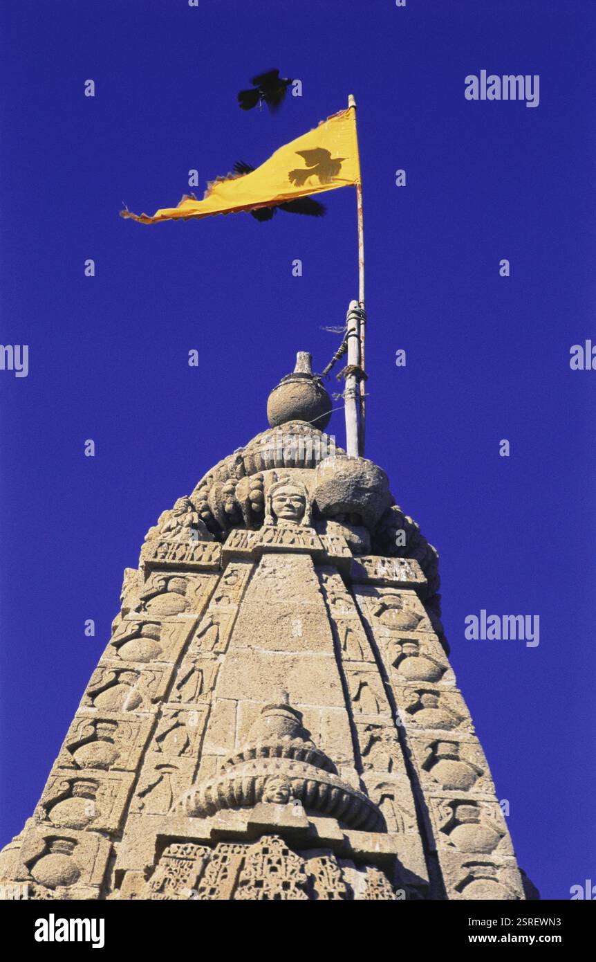 Yellow flag and crow over Ruksh mani temple, Dwarka, Gujarat, India ...