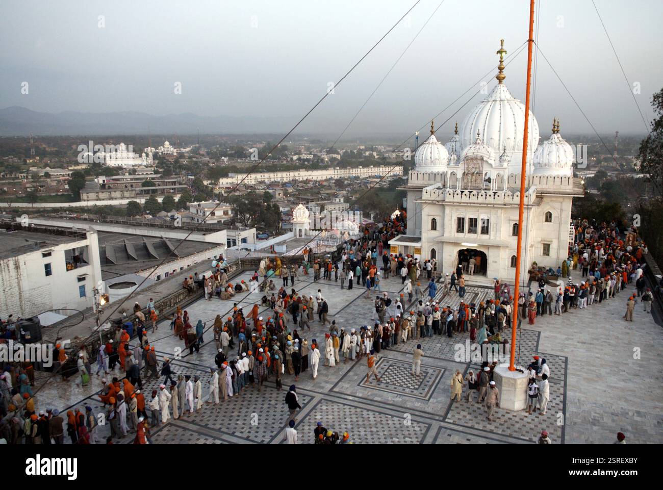 Sikh devotees in queue in front of gurudwara anandgarh sahib during hola mohalla festival ...