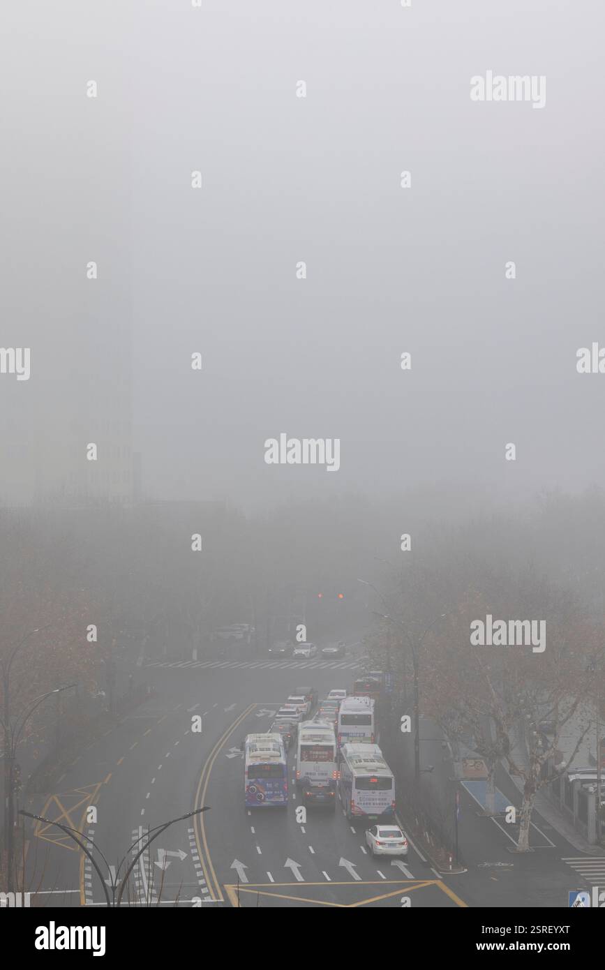 HANGZHOU, CHINA - FEBRUARY 16, 2025 - Vehicles drive slowly through ...