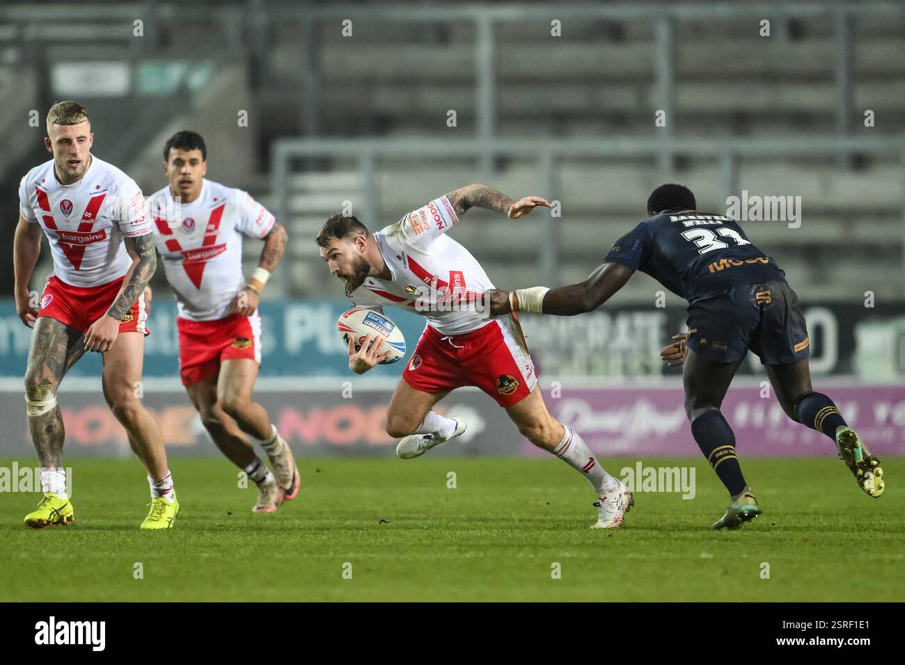 Daryl Clark of St. Helens breaks past Bardyel Wells of Salford Red ...