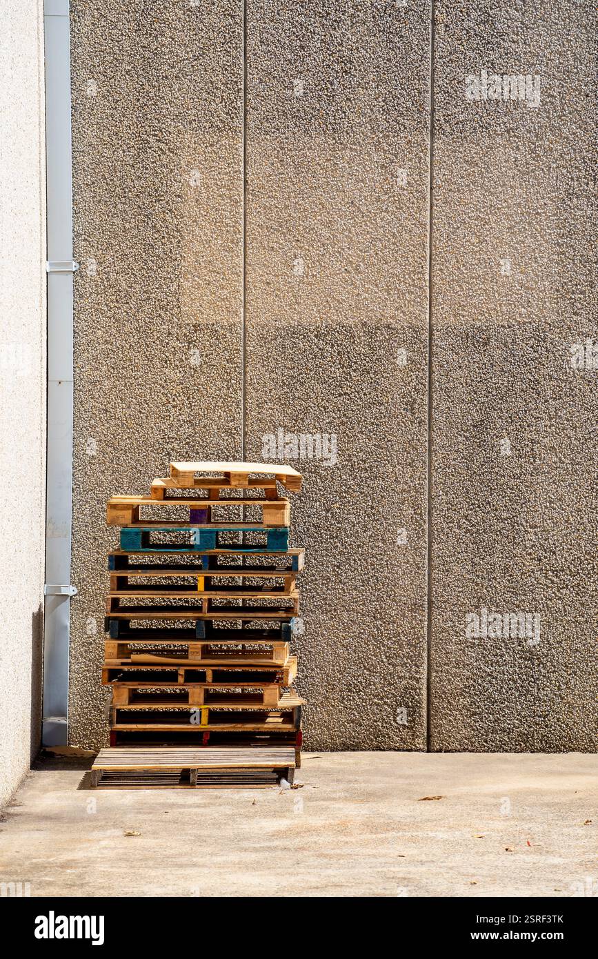 Softwood timber pallets stacked in front of a tilt up prefabricated ...