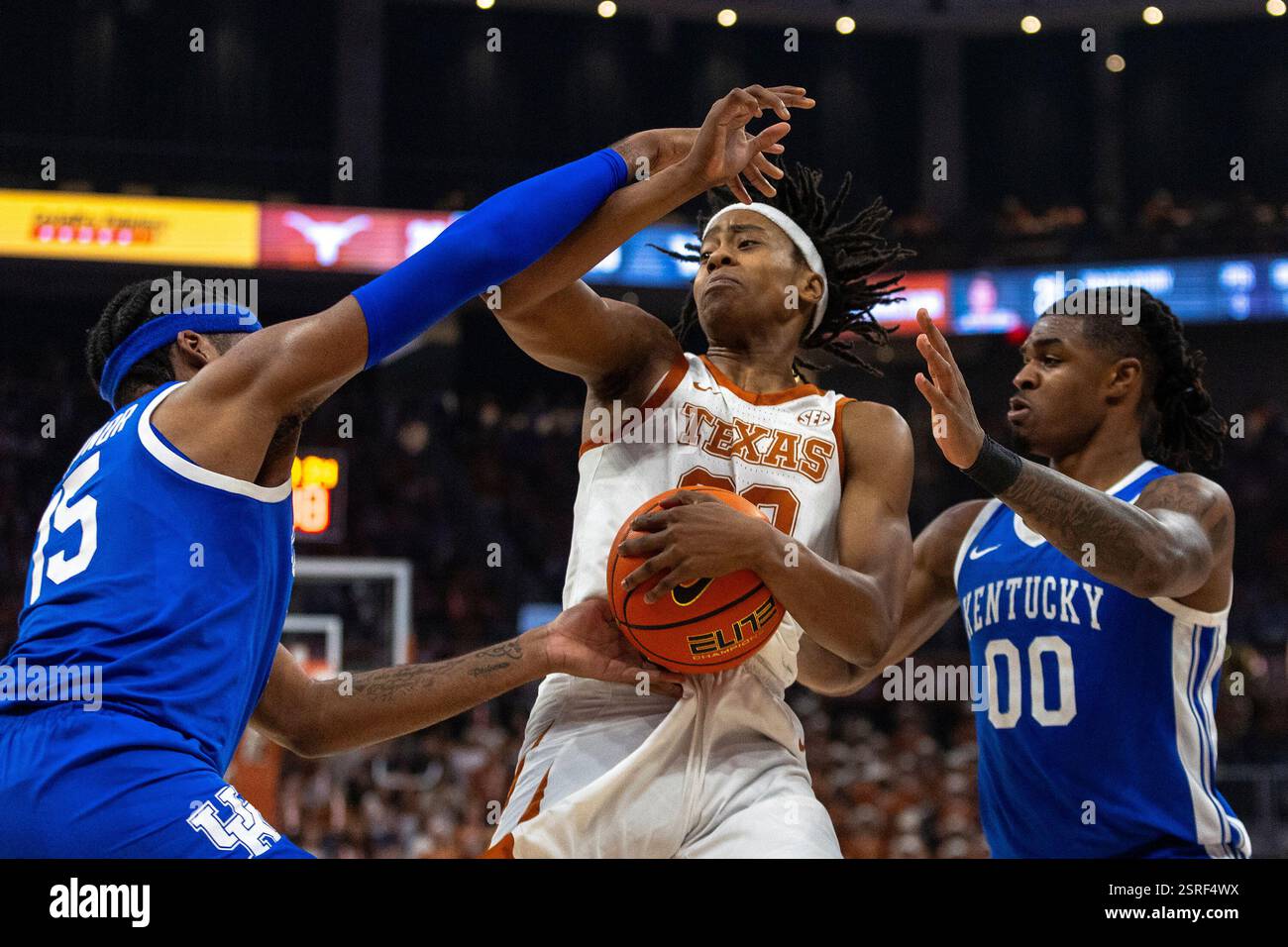 Texas guard Tre Johnson, center, is defended by Kentucky forward Ansley ...