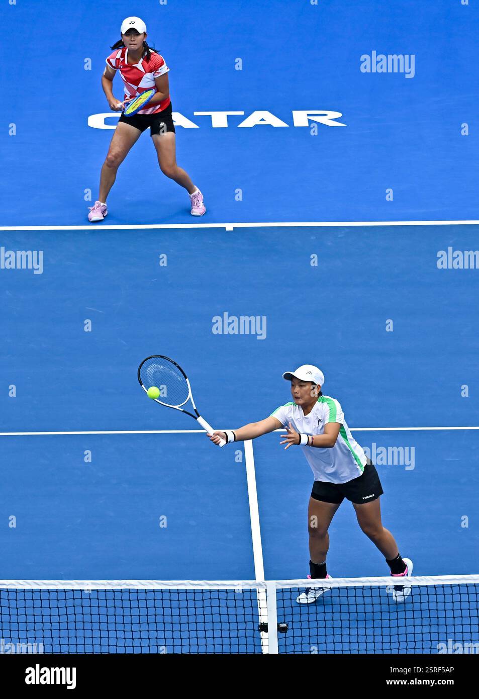 Doha, Qatar. 15th Feb, 2025. Jiang Xinyu (R)/Wu Fang-Hsien compete ...