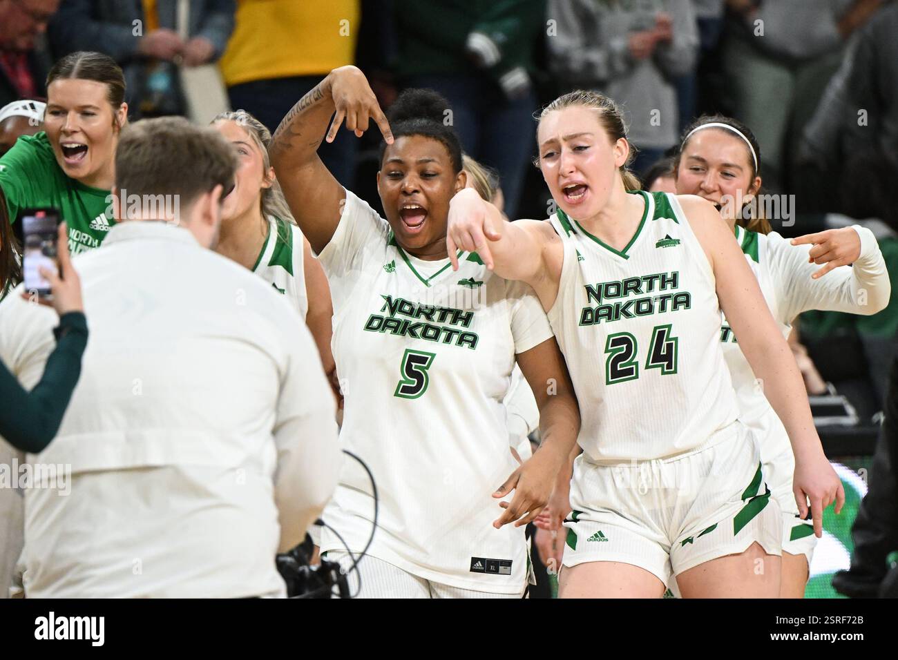 North Dakota players celebrate winning a NCAA women's basketball game ...