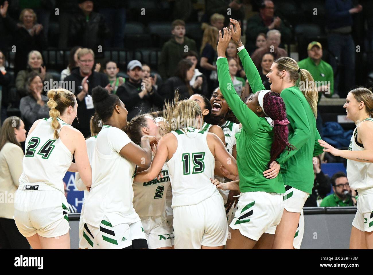 North Dakota players celebrate winning a NCAA women's basketball game ...