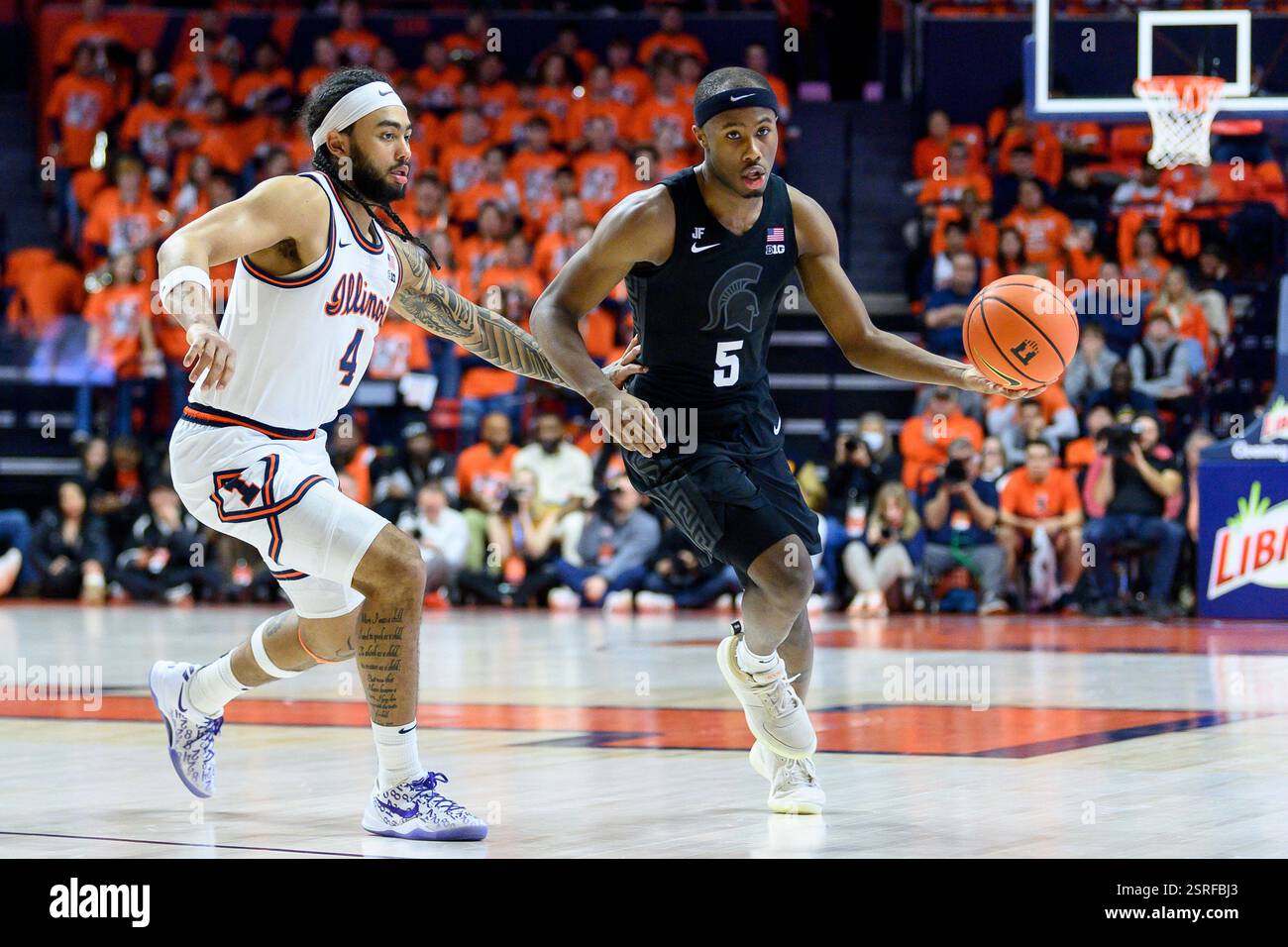 Michigan State's Tre Holloman advances the ball as Illinois' Kylan ...