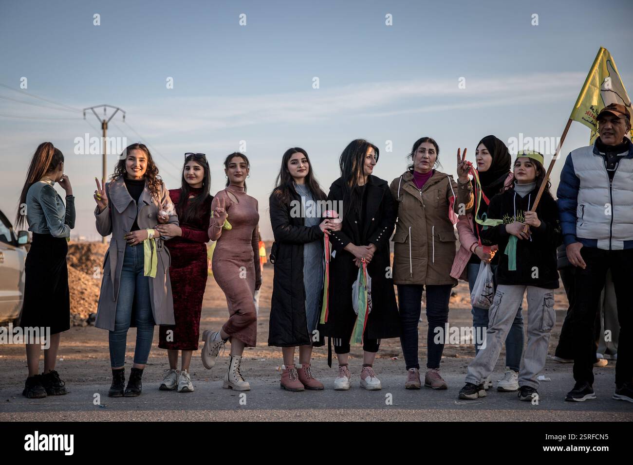 Hasaka, Syria. 15th Feb, 2025. Crowds welcome back a convoy of civilians who spent days at the ...