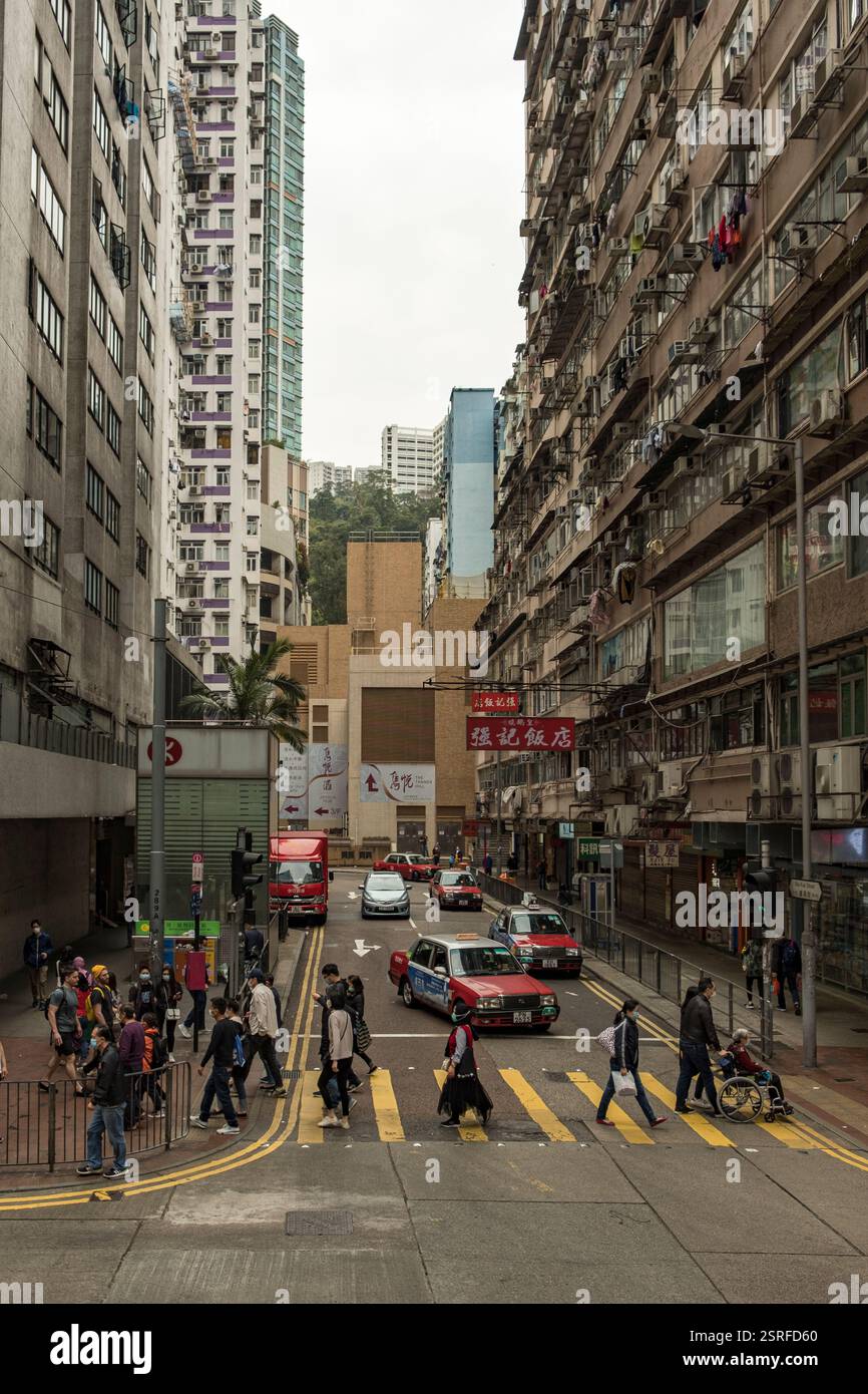A bustling street scene in North Point, Hong Kong, featuring high-rise buildings and busy ...