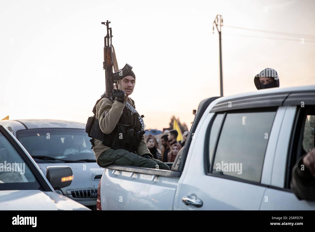 Hasaka, Syria. 15th Feb, 2025. An armed man sits on the back of a ...