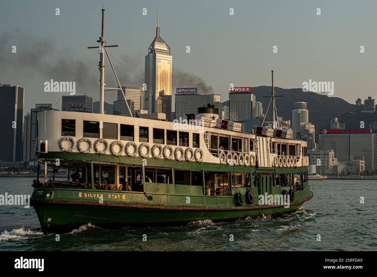 A traditional Star Ferry, the Silver Star, crosses Victoria Harbour ...