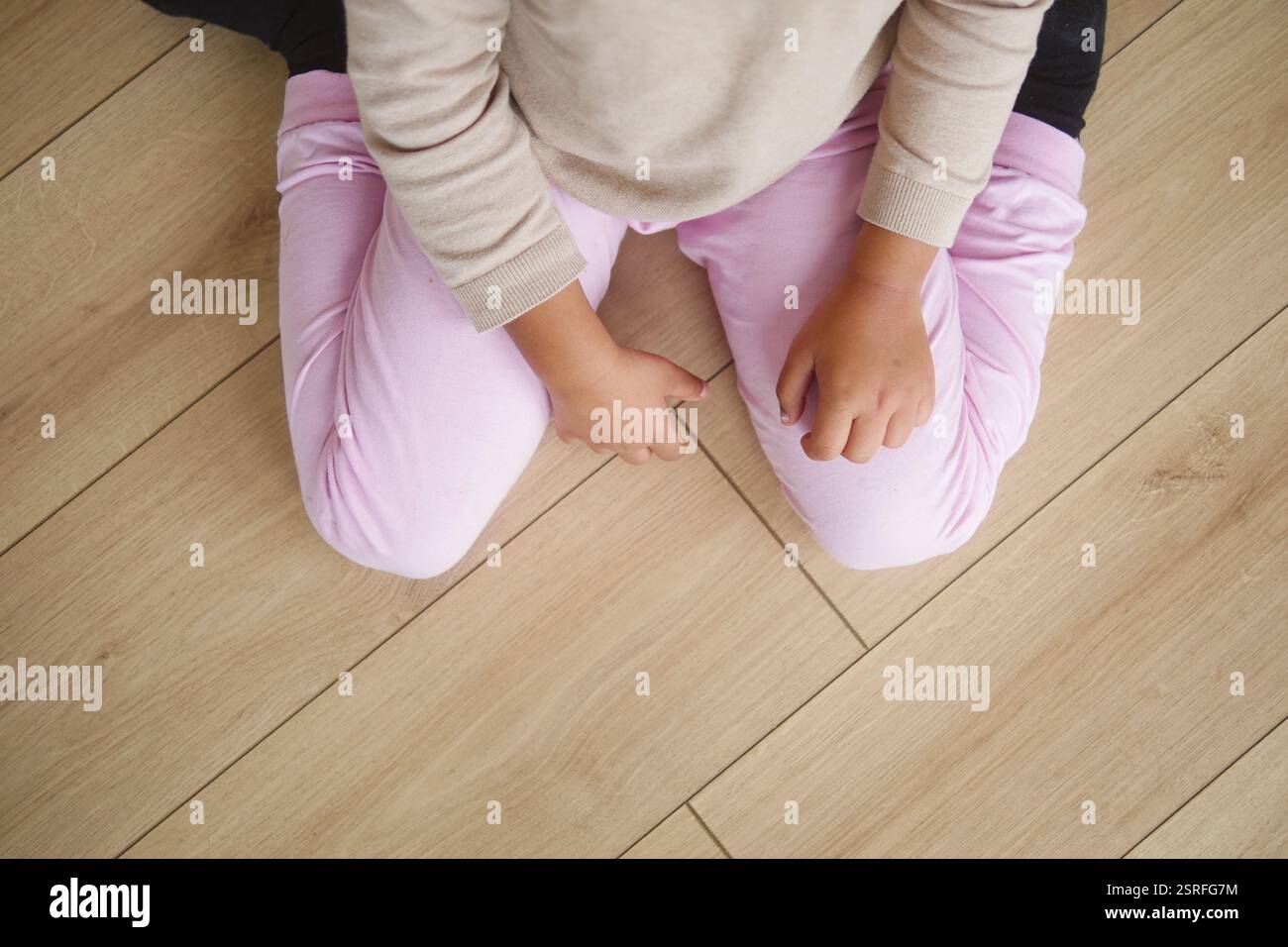 Child sitting w shape on floor Stock Photo - Alamy